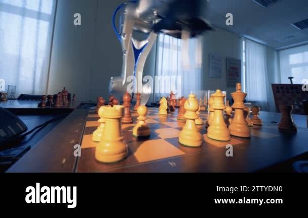 Artificial intelligence concept. Innovative modern robotic arm playing ...