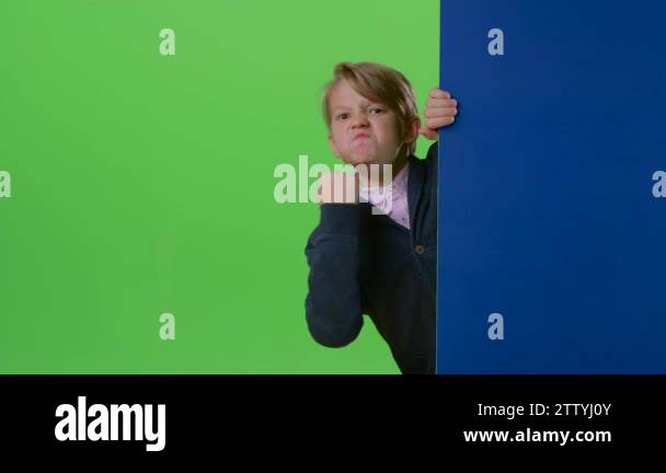 Teenage emerges from behind the boards and shows his fist on a green ...