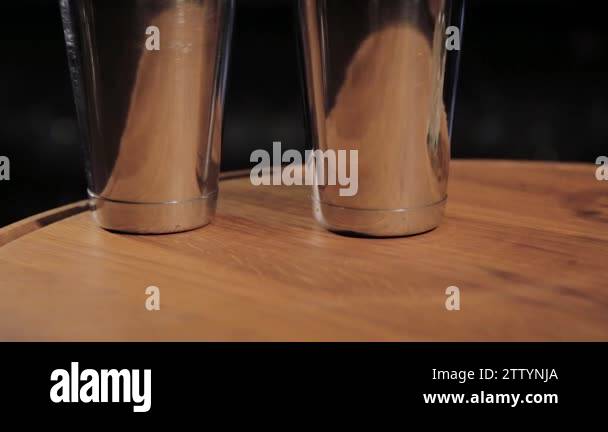 Cocktail shaker and beaker for preparation beverages on bar counter in ...