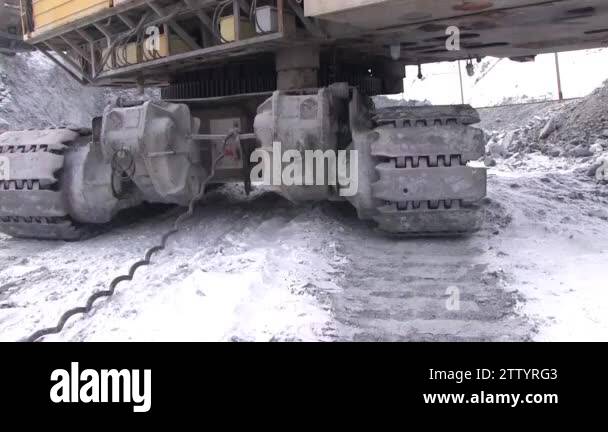 The excavator goes and pulls the electric cable.Heavy excavator in the ...