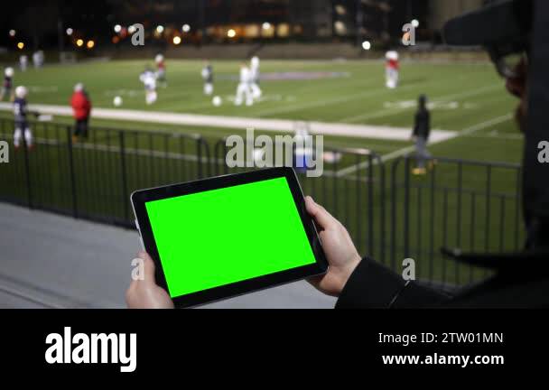 Man watches Green Screen Tablet at a Football Team Practice Session ...
