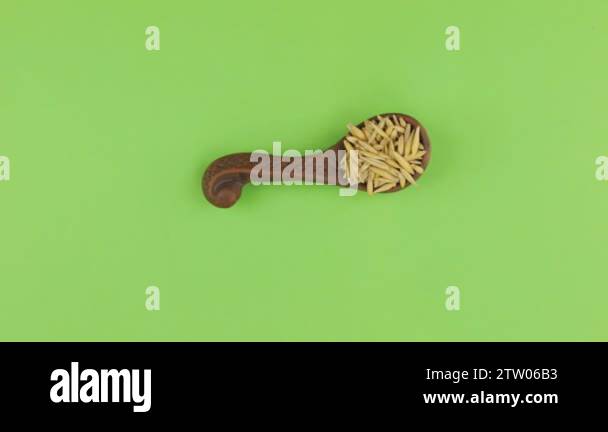 Rotation and approach of the spoon with oat grains, green screen Stock ...