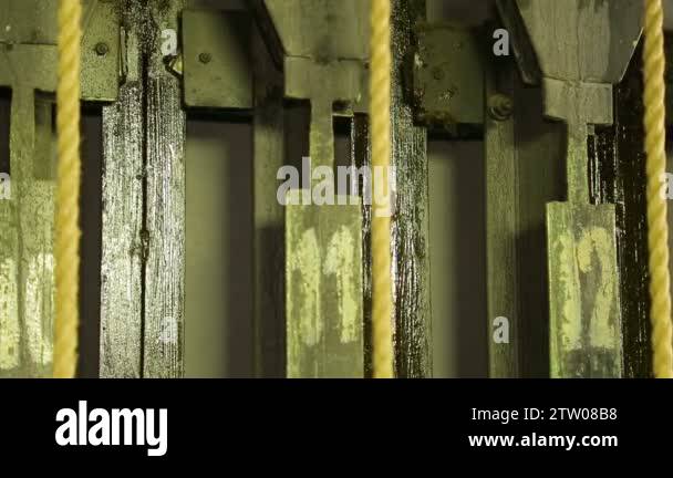 male scene worker removes load from the lifting mechanism of a theater ...