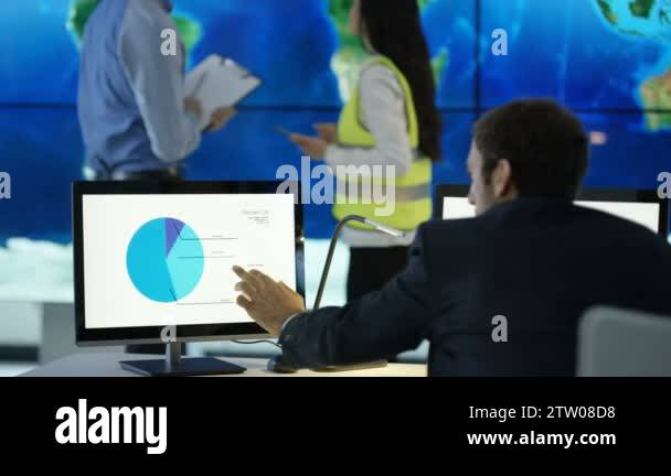 4K Business team discussing large world map graphic on video wall, with ...