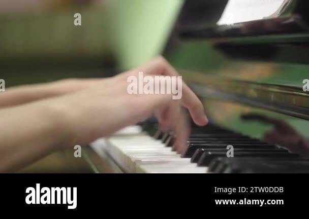 young man playing the piano. hands close up. exercises on the musical ...