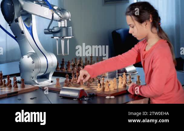 Little girl and robotic arm are capturing chess pieces of each other ...