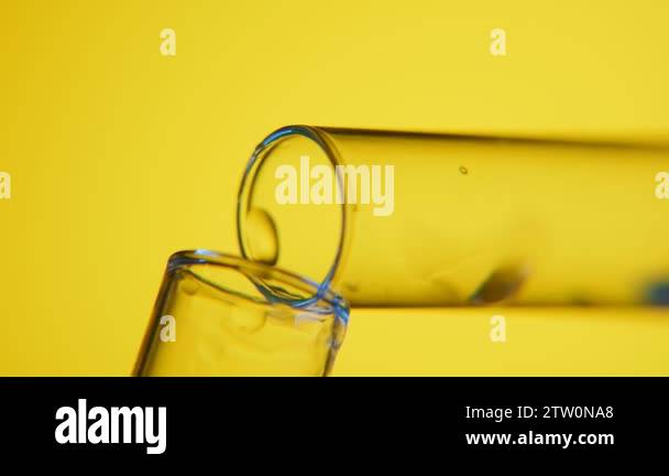 Chemical fluid flows from one test tube into another in a medical ...