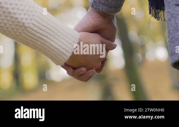 Boy and girl slowly let go of each other hands, symbol of break-up and ...