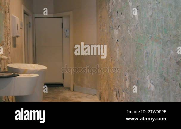 Public restroom renovation in messy stage with tiles removed from the ...