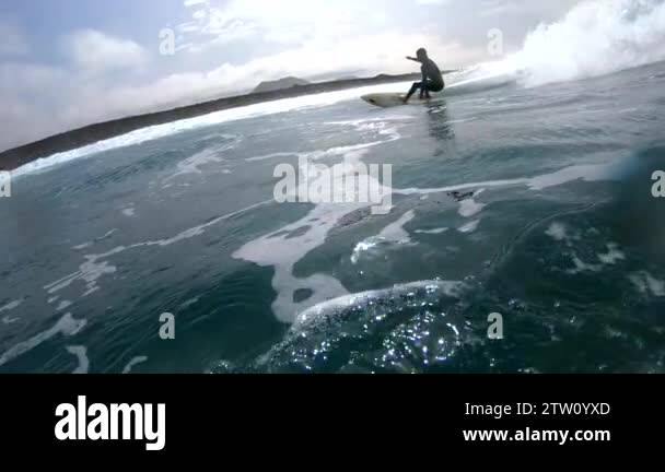 SLOW MOTION UNDERWATER: Experienced surfer guy carving a big blue wave ...
