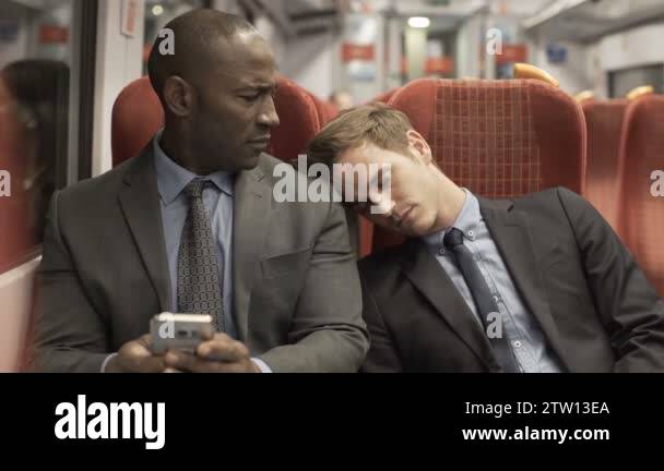 4K Tired businessman falling asleep on another passenger on commuter train Stock Video Footage ...