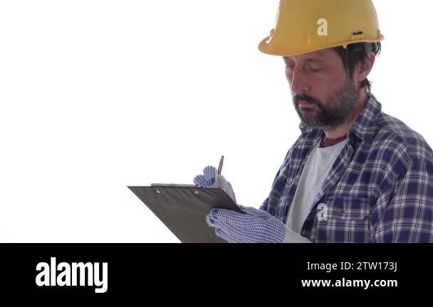 Construction worker writing project notes on clipboard notepad ...