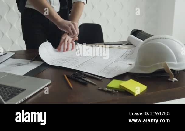 Close-up A person is an architect or planner working on drawings for ...