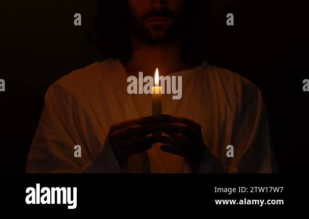 Jesus Christ with burning candle standing in darkness, bringing hope ...