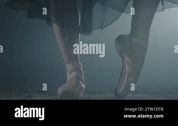 Female slim legs standing in pose and make steps on black background in ...