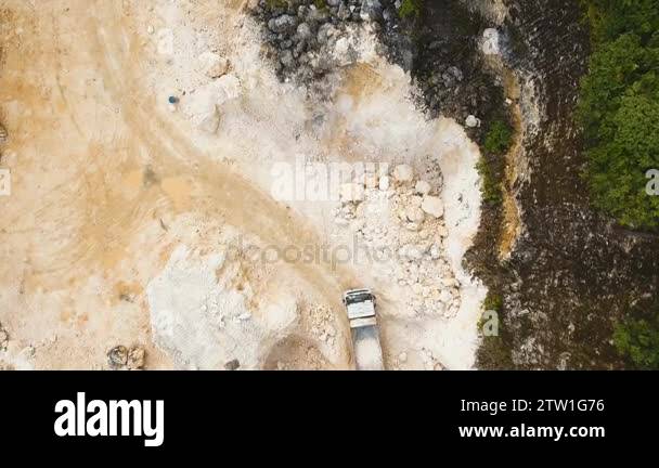 Excavator loads truck in quarry. Philippines,Siargao Stock Video ...
