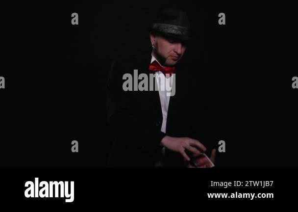 Young magician shows magic playing card trick show concept trick on ...