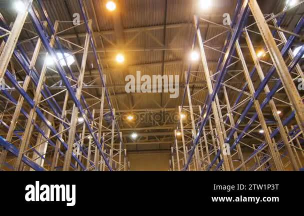 camera moves back along huge warehouse providing goods picking checking ...