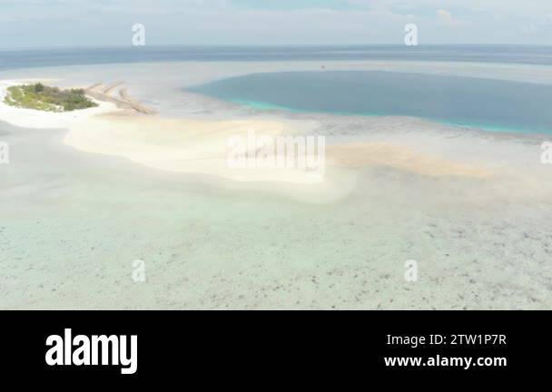 Aerial: Flying over idyllic atoll, travel destination Wakatobi National ...