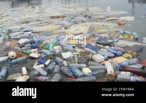 Environmental pollution. Plastic bottles, bags, trash in river, lake ...