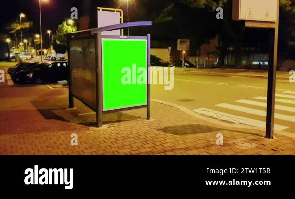 billboard with a chroma key green screen on a traffic cars city night ...