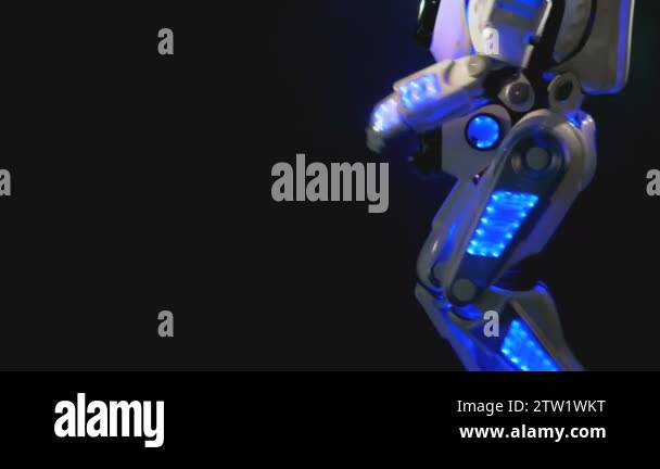 A smiling robot goes near the camera to stop and wave its arm. 4K Stock ...