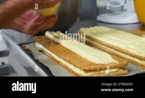 baker decorating pastries and cakes in bakery kitchen, professional ...