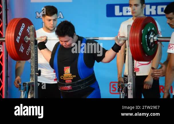 Weightlifter woman in a powerlifting competition performing squat test ...