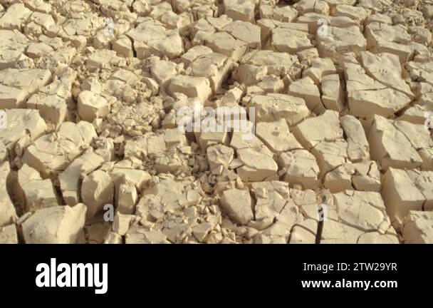 CLOSE UP: Dried up light brown soil cracking in the scorching hot ...