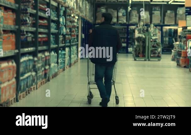 At the Supermarket: Man Pushing Shopping Cart Through Fresh Produce ...