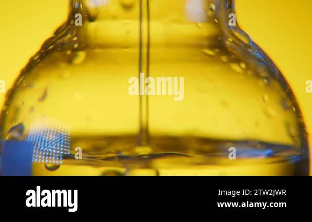 Wide volumetric flask in a medical laboratory is poured with ...