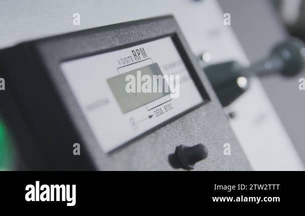 employee hand pressing black lever of lab test device control panel ...