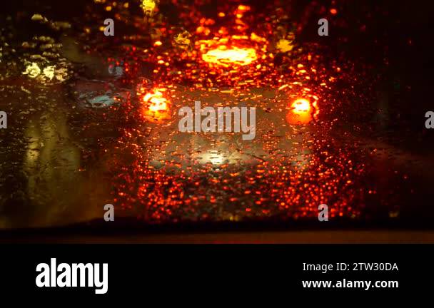 the rain streams on the front window of the windshield window of the ...