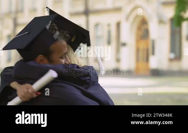 Multiethnic graduation students having fun hugging and congratulating ...