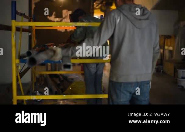 Two workers on the factory do welding operations Stock Video Footage ...