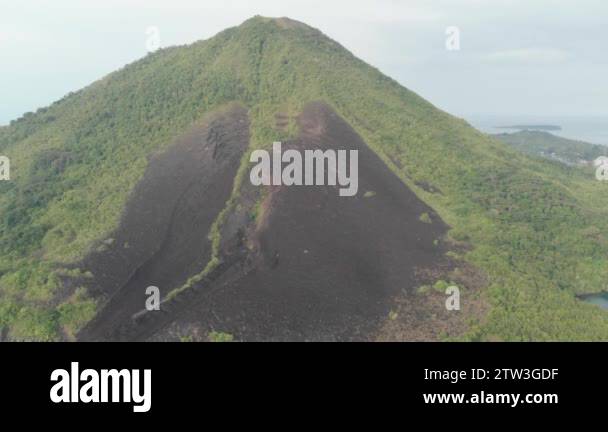 Aerial: flying over Banda Islands active volcano Gunung Api lava flows ...