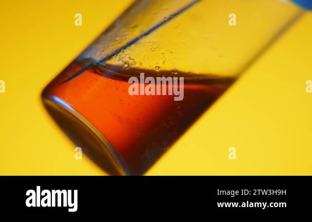 Red liquid is soaked into a syringe from a sample tube in a medial ...