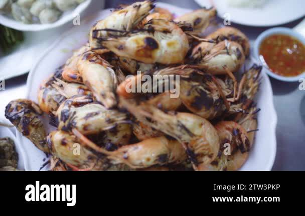 Slow motion - Young Asian woman eating shrimp seafood in restaurant ...