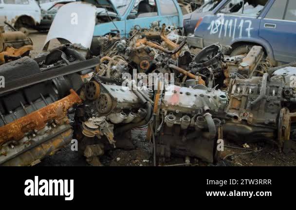 old broken car engines are lying in big stack on a ground in an area of ...