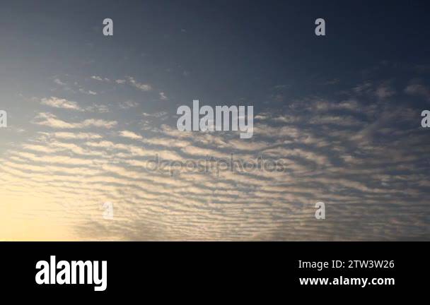 White clouds disappear in the hot sun on blue sky. Time-lapse motion ...
