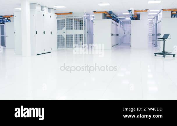 Empty interior of large modern data centre with rows of server racks ...