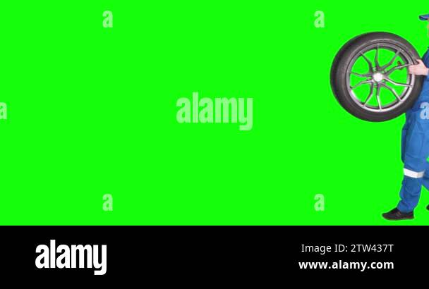 Caucasian car mechanic walking in the studio while wearing blue uniform ...