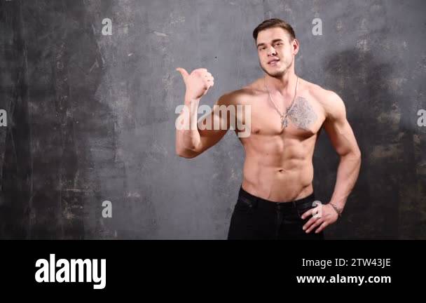 Strong and Muscular man bodybuilder. Man posing on a black background ...