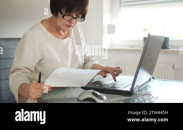 A business woman pays bills using a computer, internet payments ...
