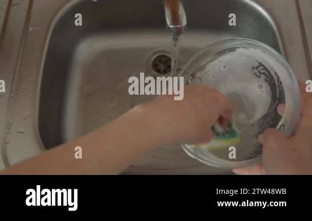 Washing dishes in the sink at home. Cleaning after cooking Stock Video ...