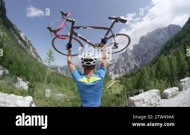 SLOW MOTION, CLOSE UP: Unrecognizable fit biker stands at the side of ...