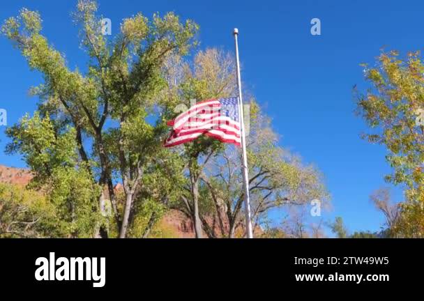 The American Flag On The Flagpole Is Lowered On The Day Of Mourning ...