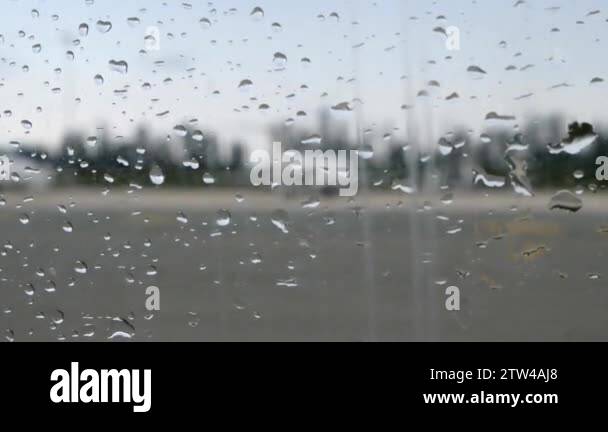 Airplane window with raindrops. Blurry view of the airplane through the ...