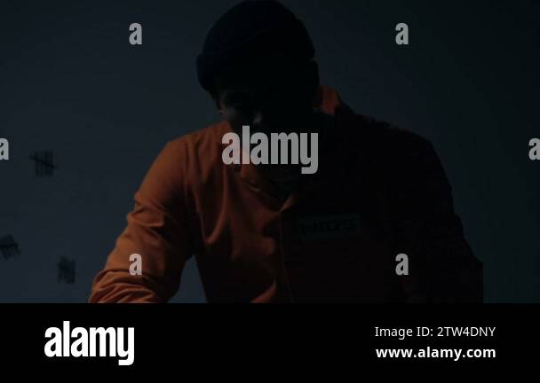 Angry prisoner sitting in dark individual cell, punishment for disorder ...