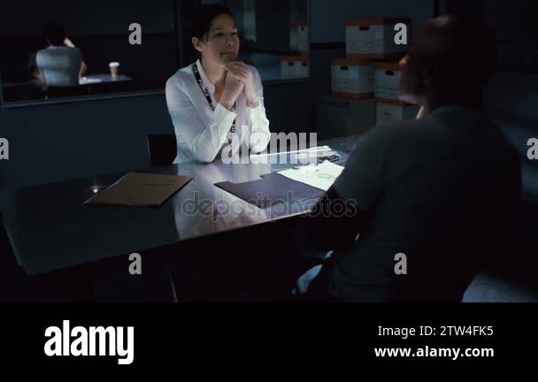 4K Female police detective questioning a crime suspect in interrogation ...